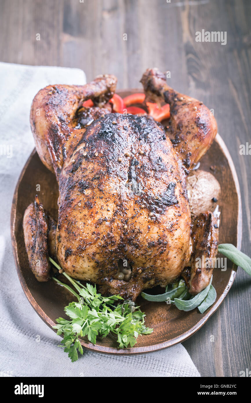 Grilled chicken on wooden plate vertical Stock Photo - Alamy