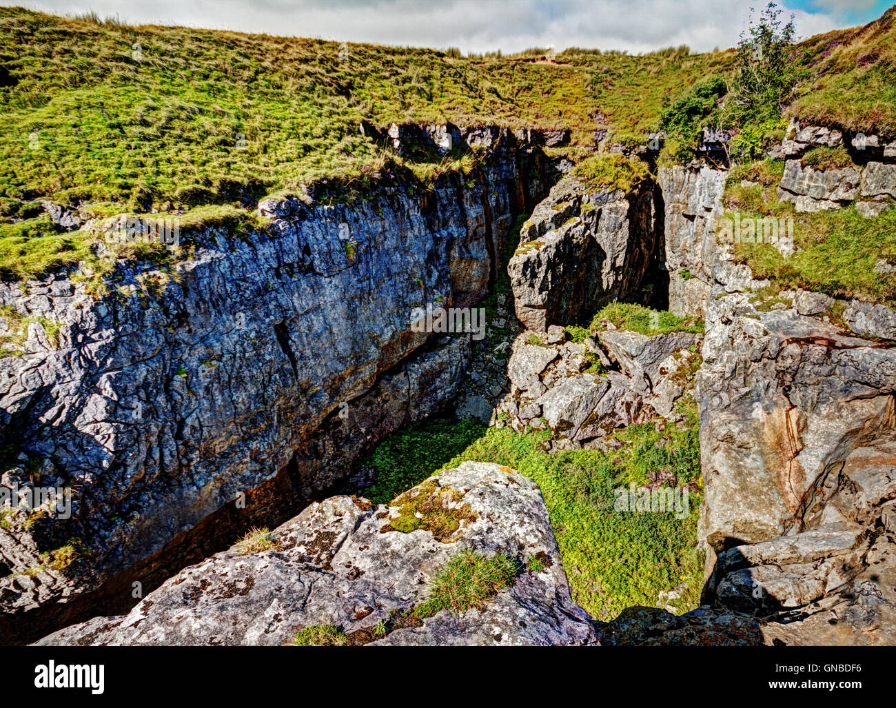 On the ledge of Hull Pot Stock Photo - Alamy