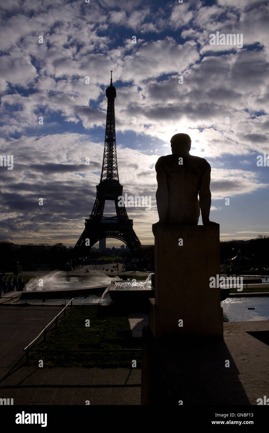 Backlit Eiffel Tower with statue Stock Photo - Alamy