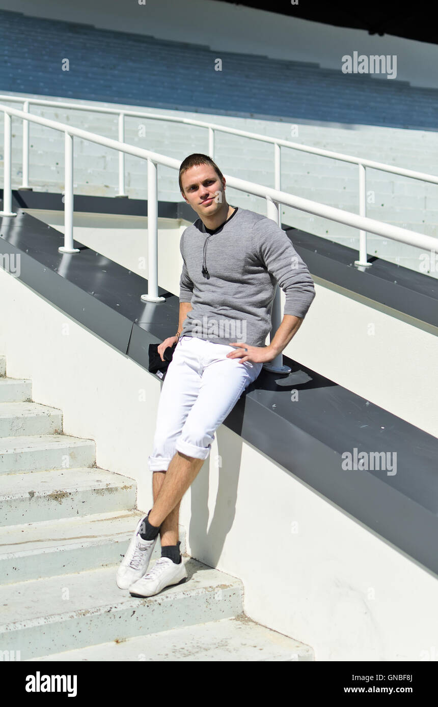 Young athletic guy in an empty stadium Stock Photo - Alamy