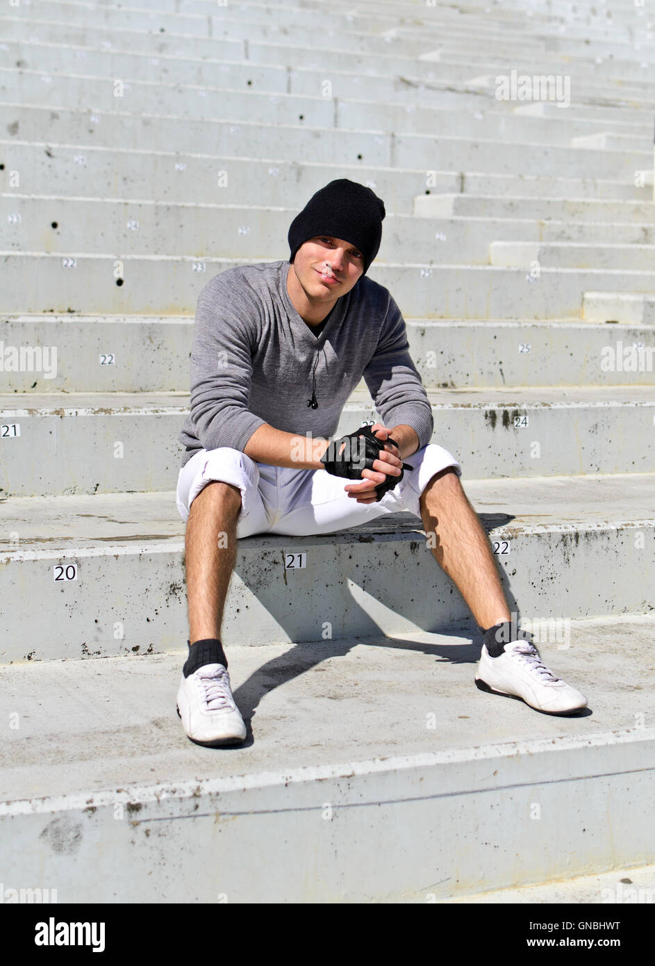 Young athletic guy in an empty stadium Stock Photo - Alamy
