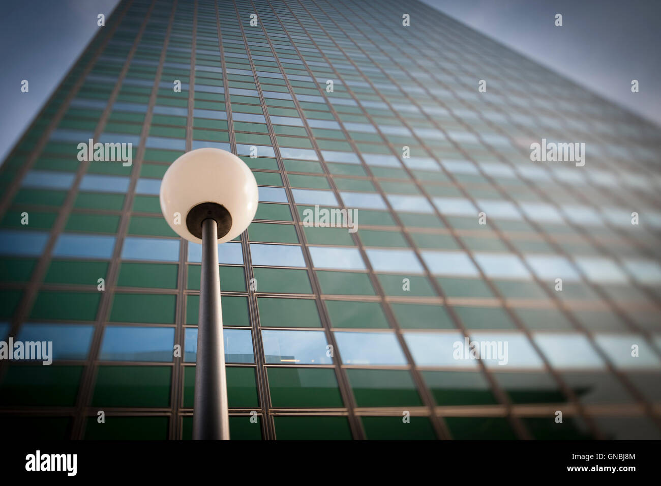 Lamp post in front office building facade Stock Photo - Alamy