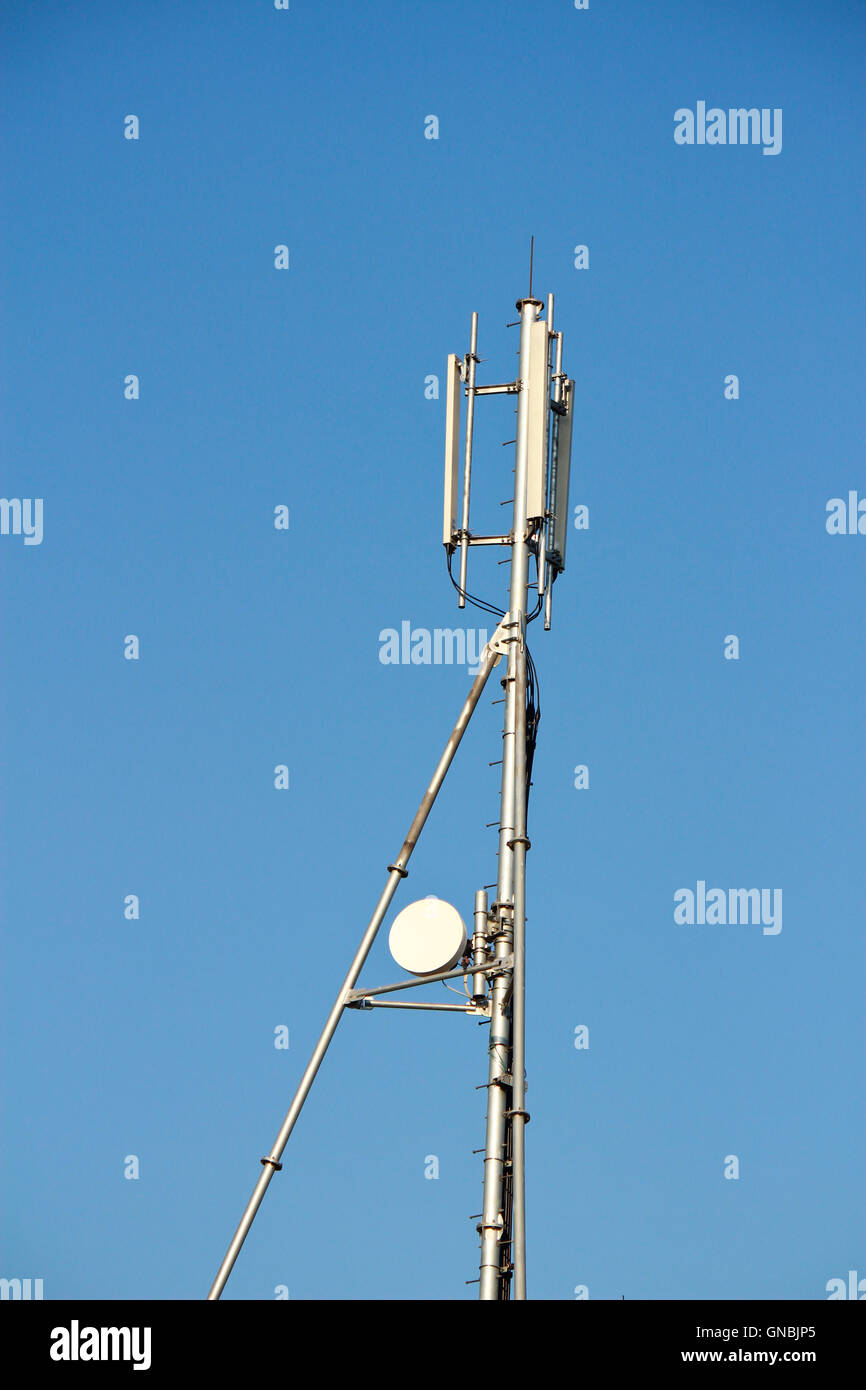 Modern cell and antenna with flat parabola on blue sky Stock Photo - Alamy