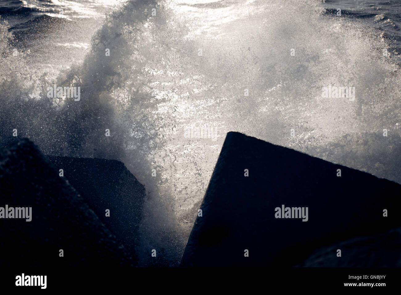 Tidal wave with 2 concrete blocks Stock Photo - Alamy