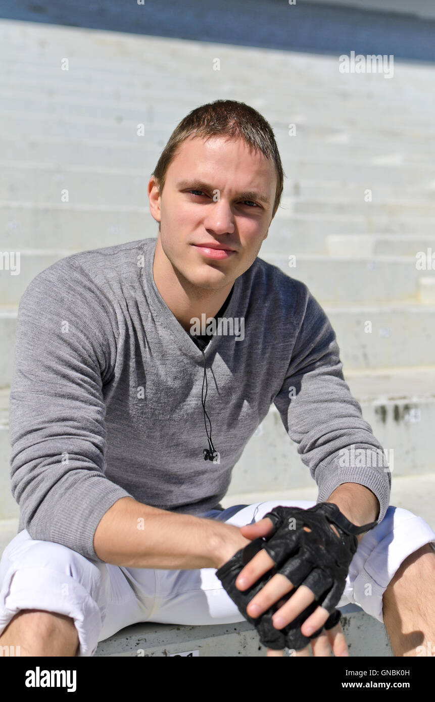 Young athletic guy in an empty stadium Stock Photo - Alamy