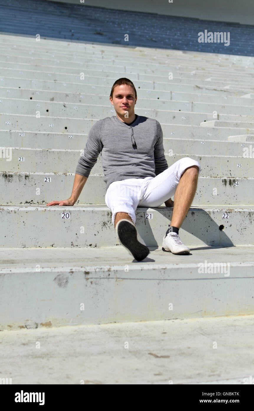 Young athletic guy in an empty stadium Stock Photo - Alamy