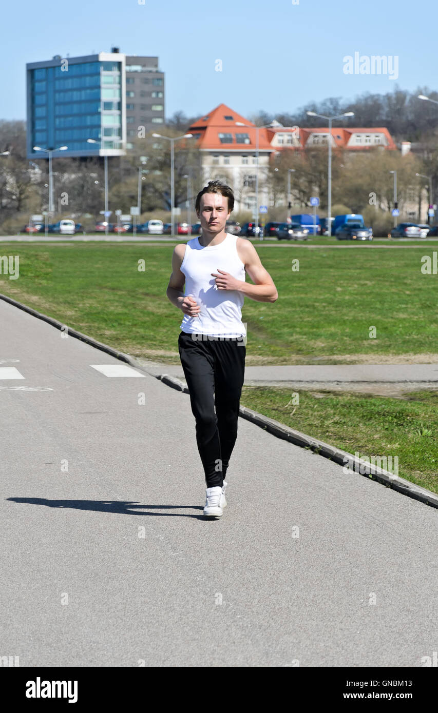 Athletic young male running around the city Stock Photo - Alamy