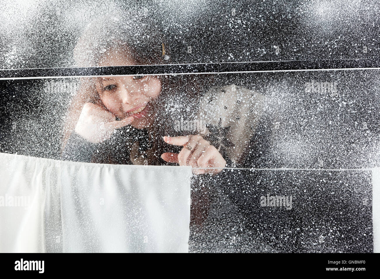 she smiles for the winter window Stock Photo - Alamy