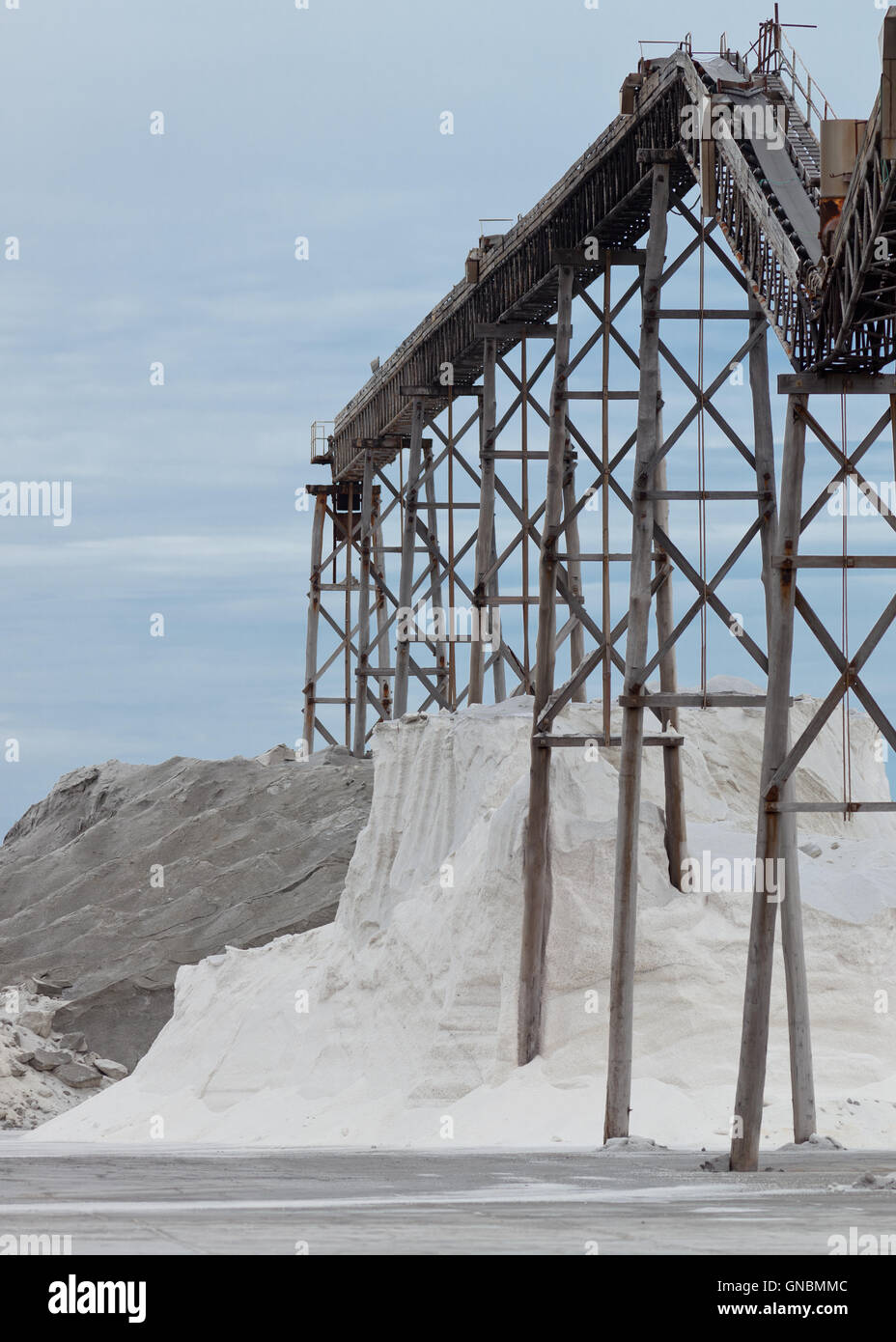 Pile of sea salt under conveyor of saline refinery Stock Photo - Alamy