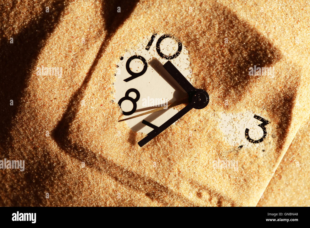 Clock In Sand Stock Photo - Alamy