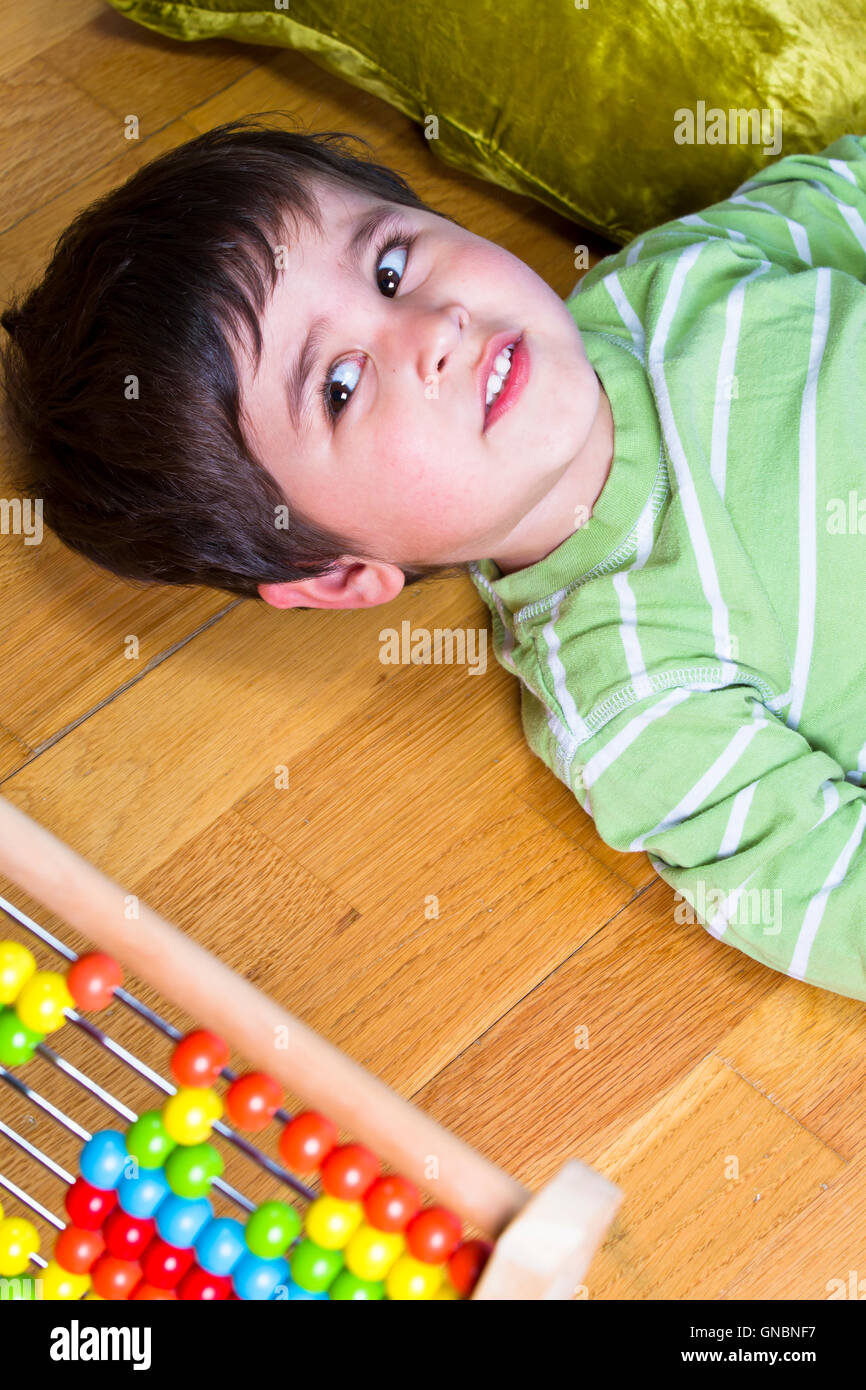 Happy little boy playing with colorful abacus, studio shot Stock Photo ...