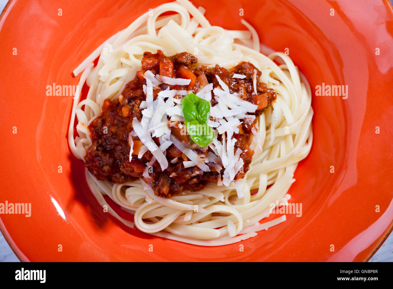 spaghetti bolognese on a red plate Stock Photo - Alamy