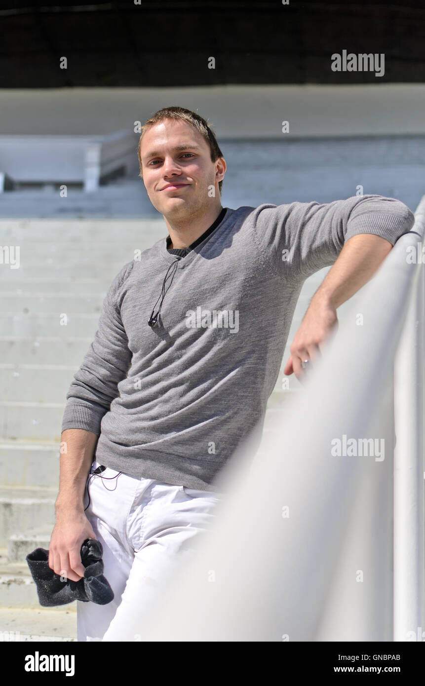 Young athletic guy in an empty stadium Stock Photo - Alamy