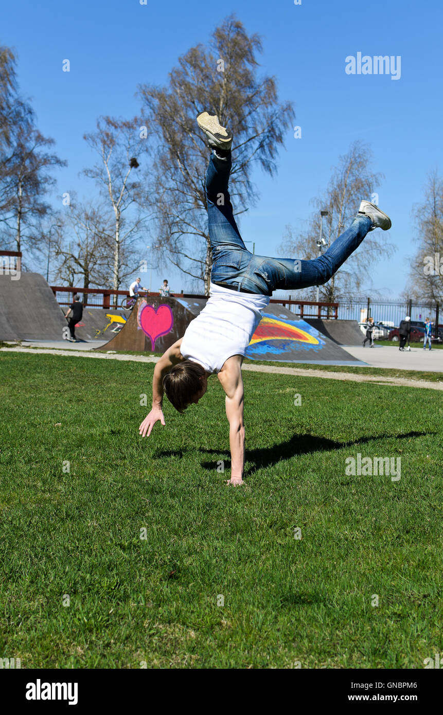 Breakdancer doing a flip on the grass Stock Photo - Alamy