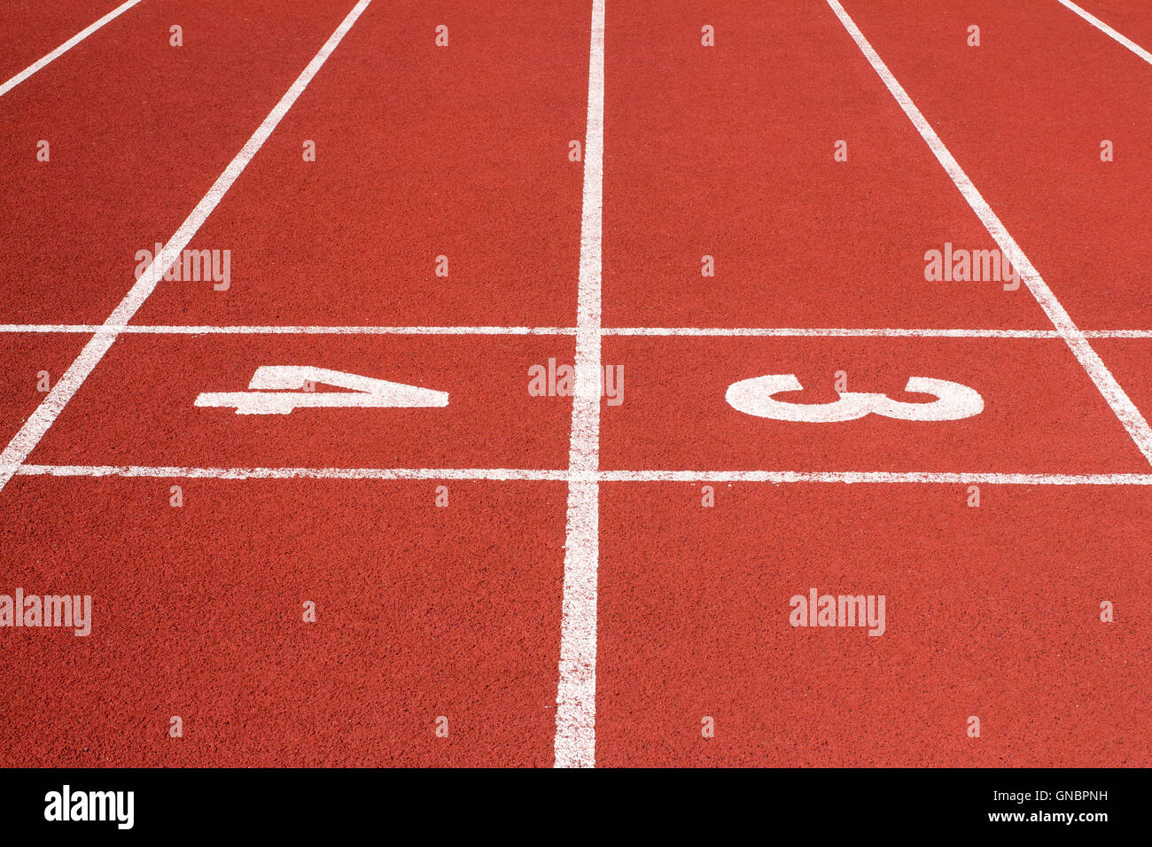 Running track with the numbers three and four Stock Photo - Alamy