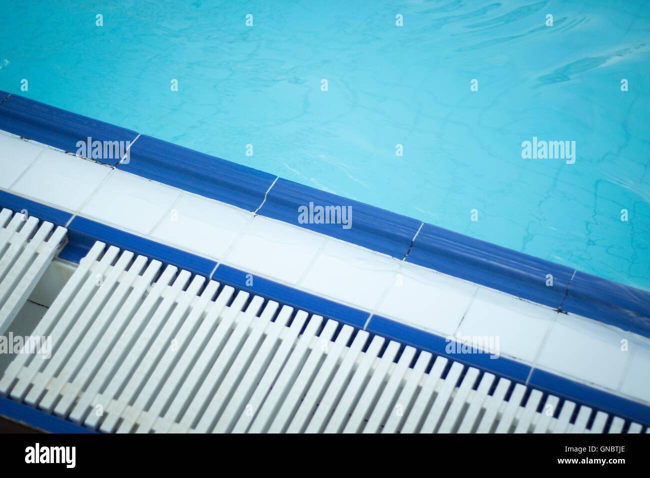 Hot summer by the outdoors swimming pool with wooden sundeck terrace ...
