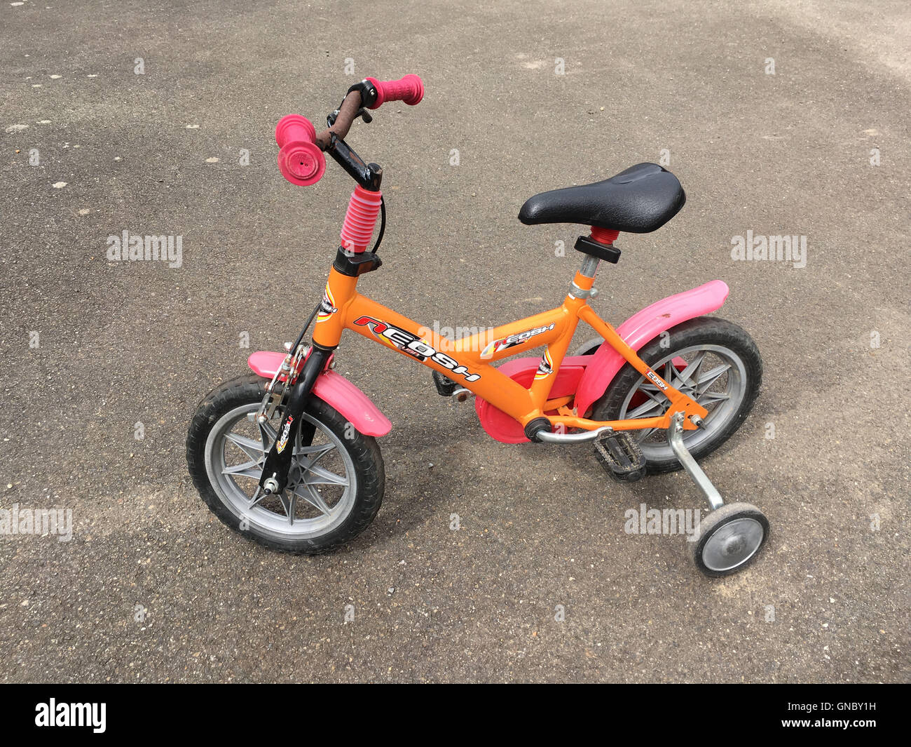 It's a photo of a orange Bicycle for kids Stock Photo - Alamy