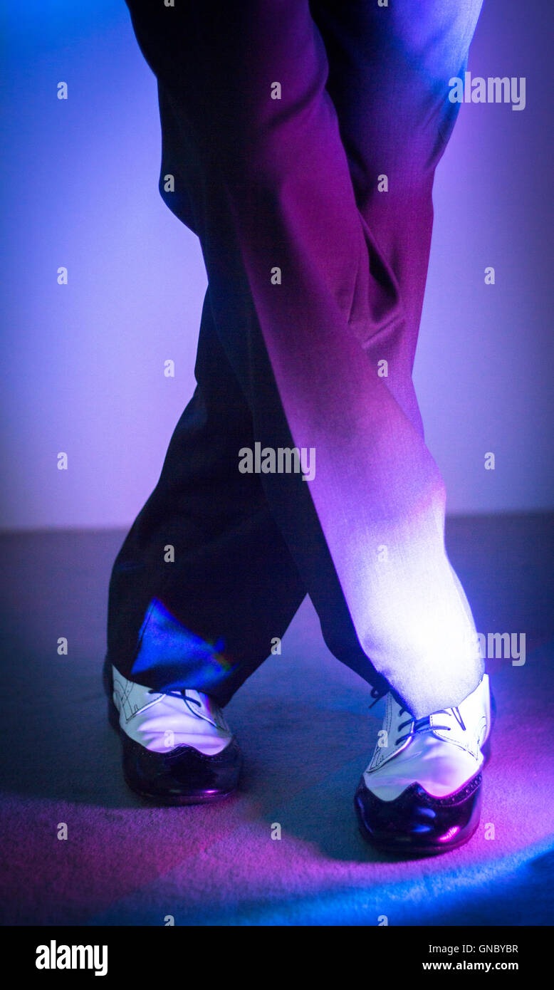 Male latin and salsa dancer in black and white jazz dancing shoes in ...
