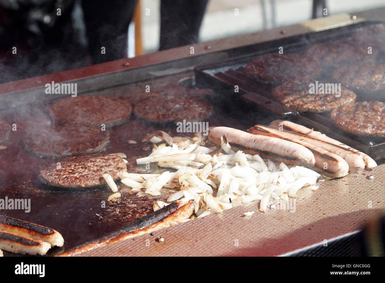 hamburger and hot dog stall selling hot fast food at an outdoor market ...