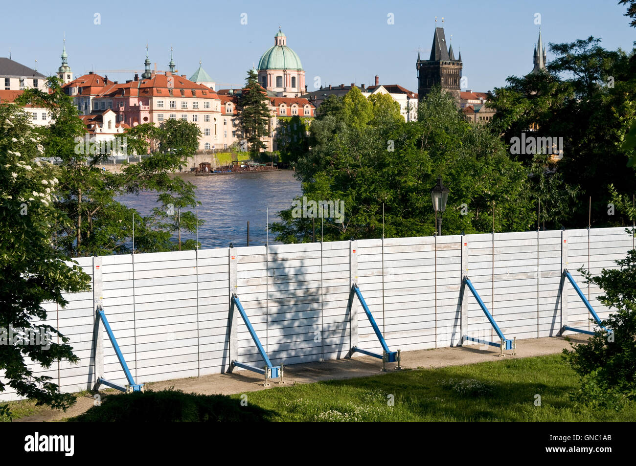 Temporary metal flood barriers were erected along the banks of the ...