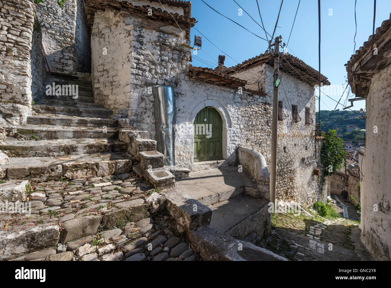 A typical narrow cobbled alleyway with ottoman period, houses in the ...