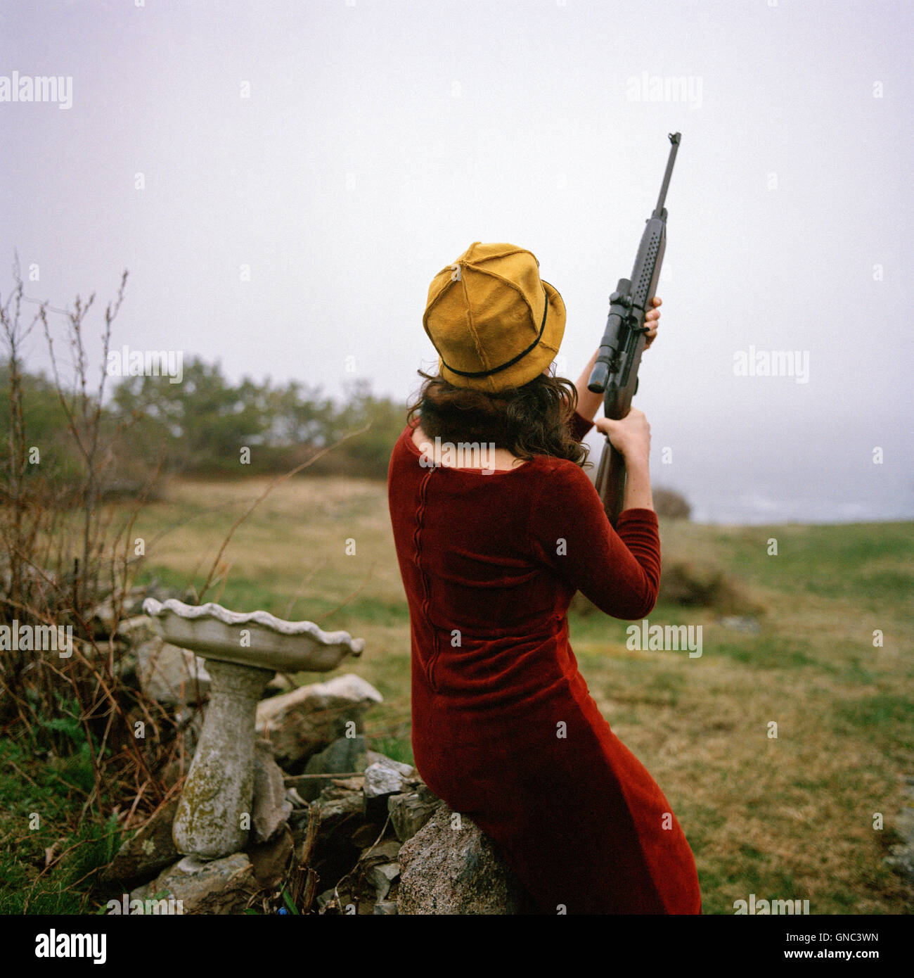 Woman in dress shooting gun hi-res stock photography and images - Alamy