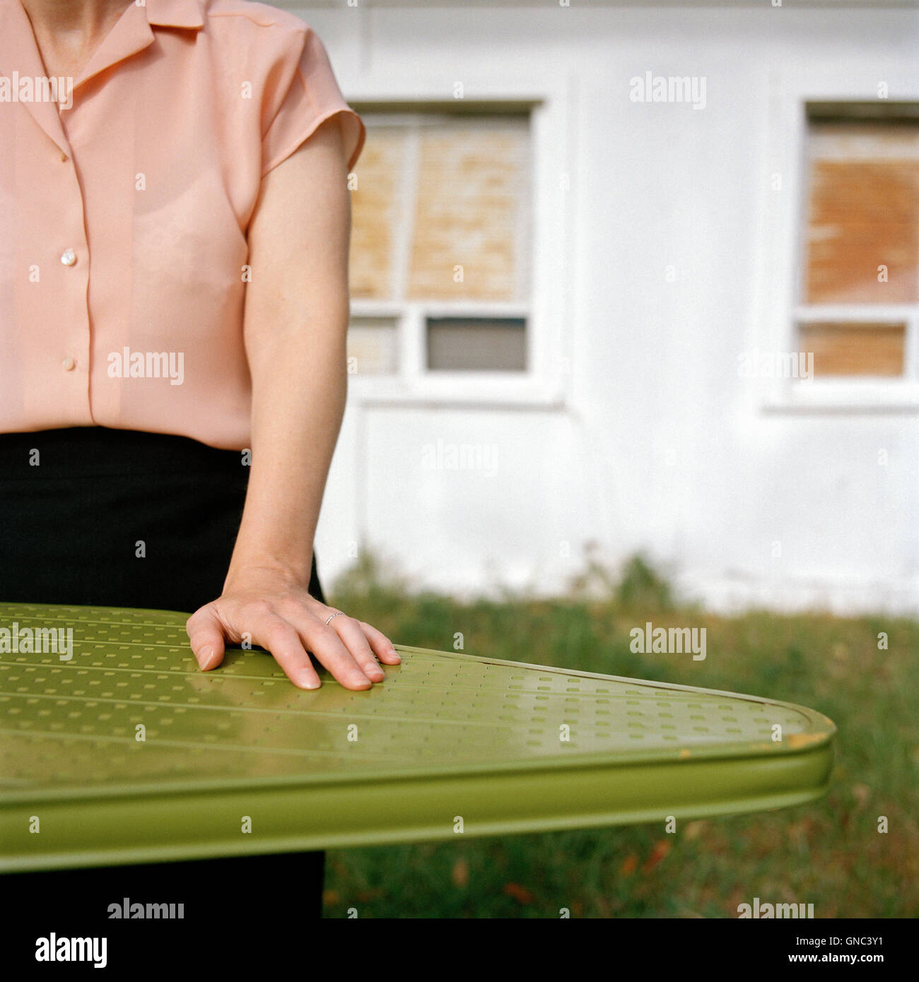 Woman's Hand on Green Ironing Board in Yard Stock Photo - Alamy