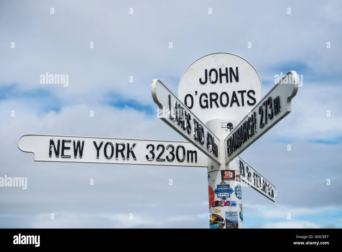 The famous multi-directional signpost at John O'Groats in Scotland ...