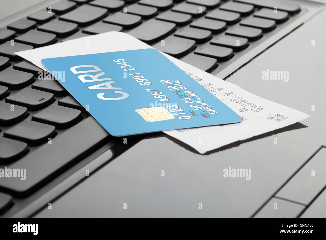Credit card and receipt over computer keyboard as symbol of online ...