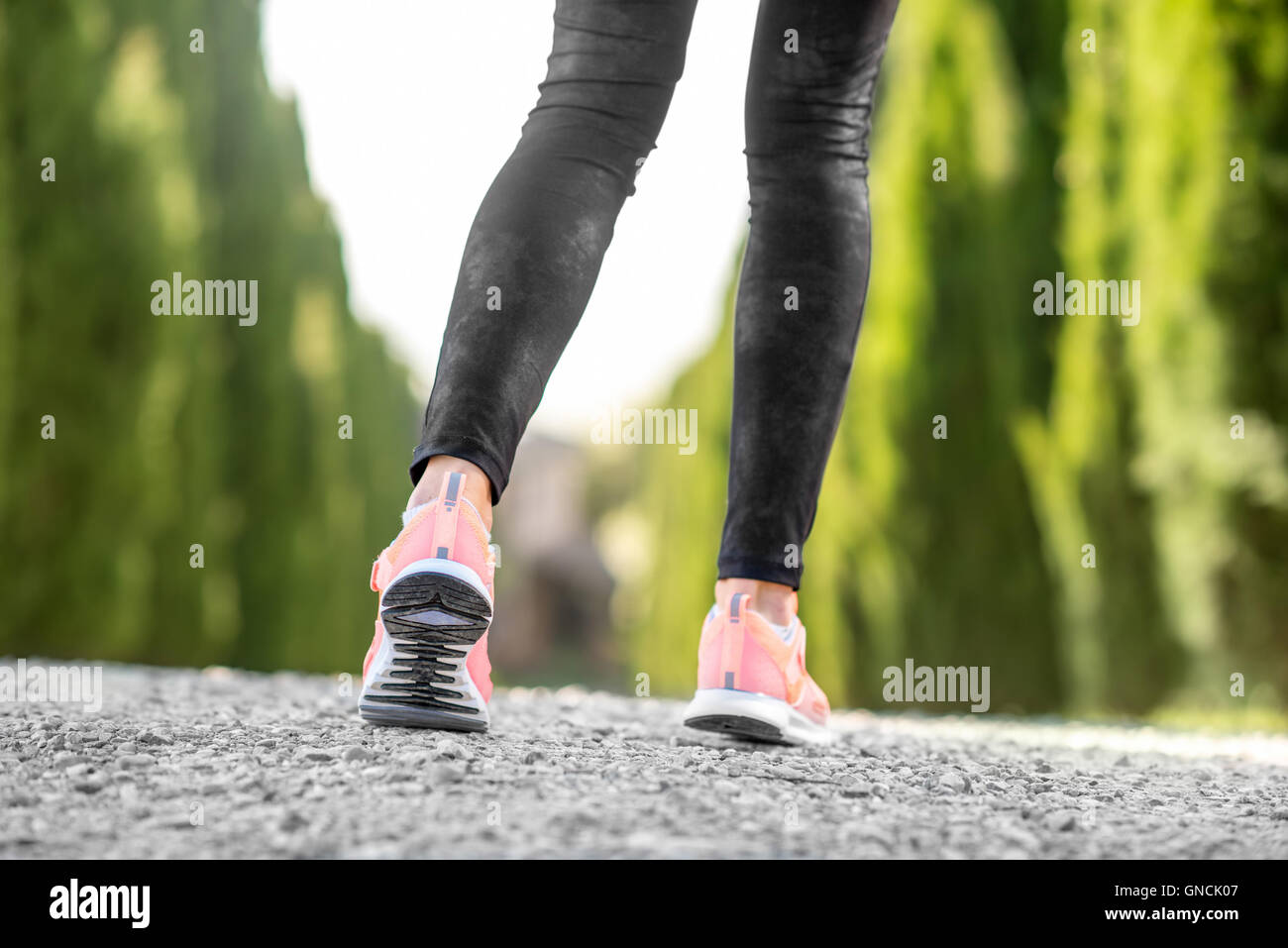 Female legs in sport sneakers Stock Photo - Alamy