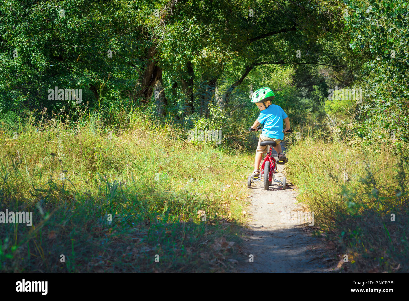 Child riding a bicycle Stock Photo - Alamy