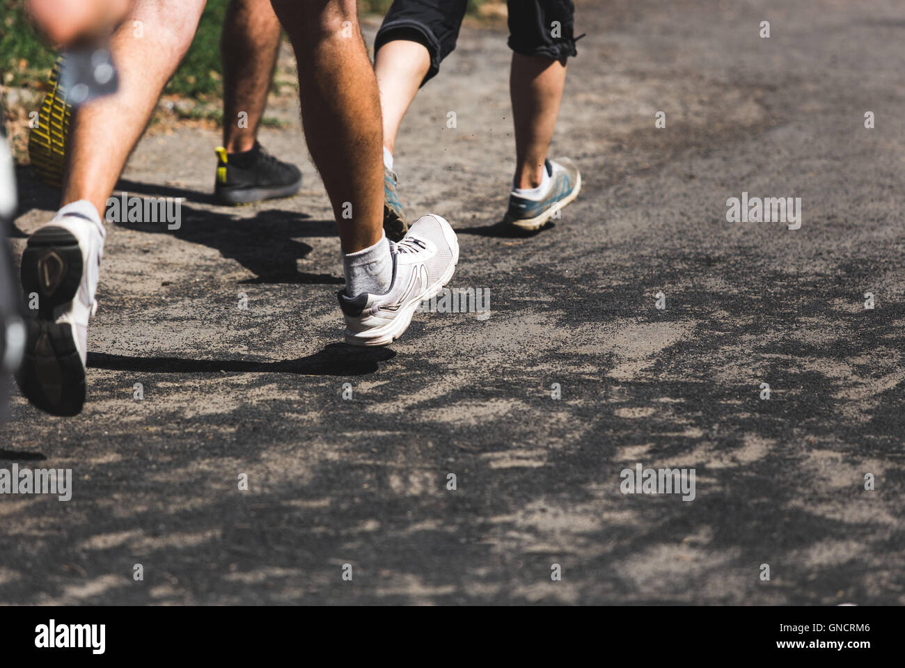Running people on crossfit competition, feet on the road close up photo ...