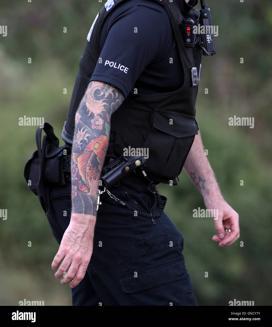 A tattoo is visible on the arm of a Police officer at the scene on ...