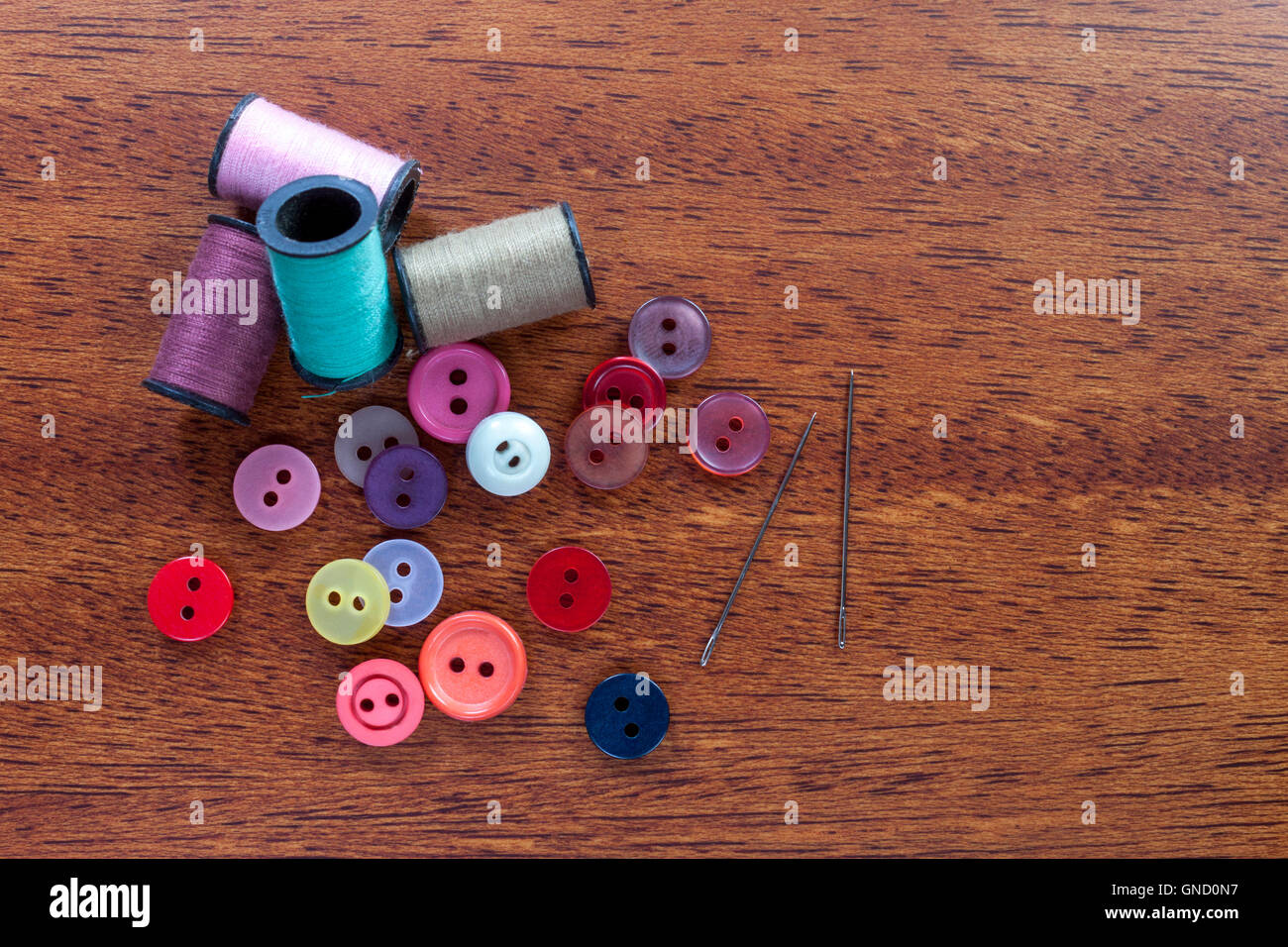 spools of cotton thread, a selection of different colored buttons and ...