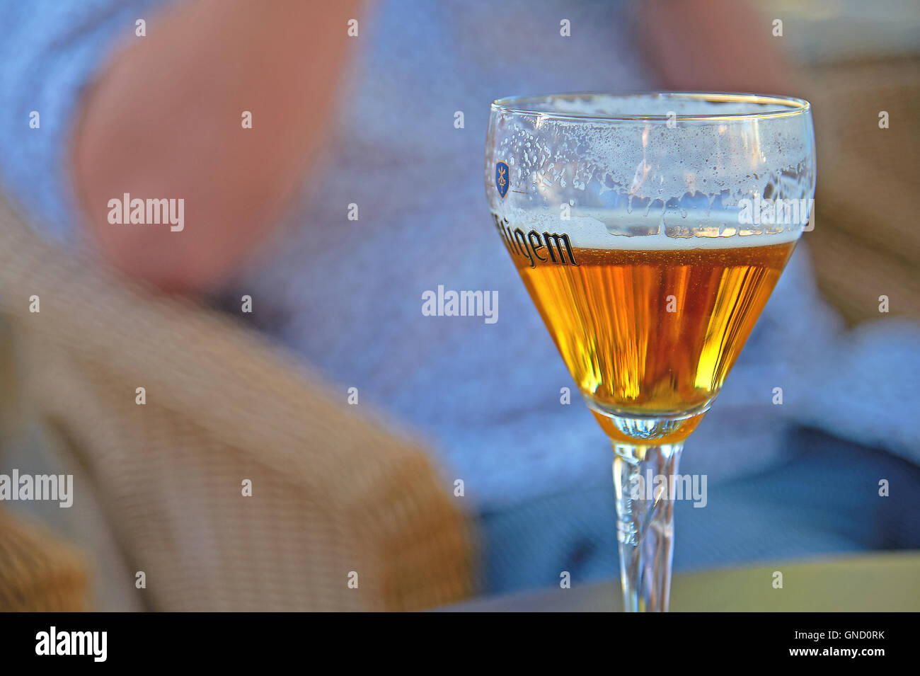 Half drunk glass of lager beer in a fluted glass Stock Photo - Alamy