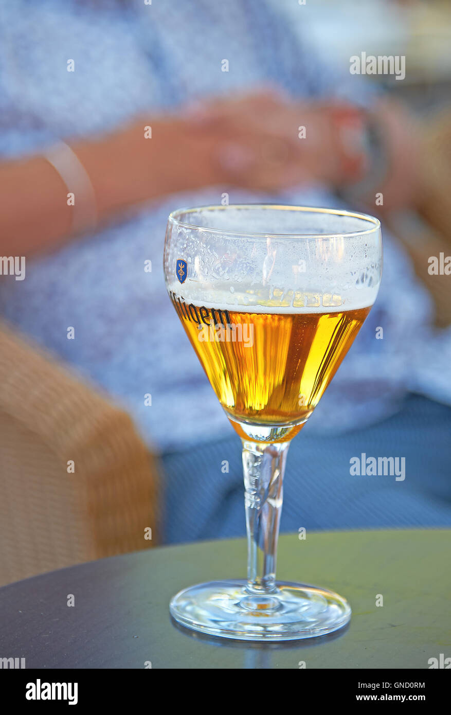 Half drunk glass of lager beer in a fluted glass Stock Photo - Alamy