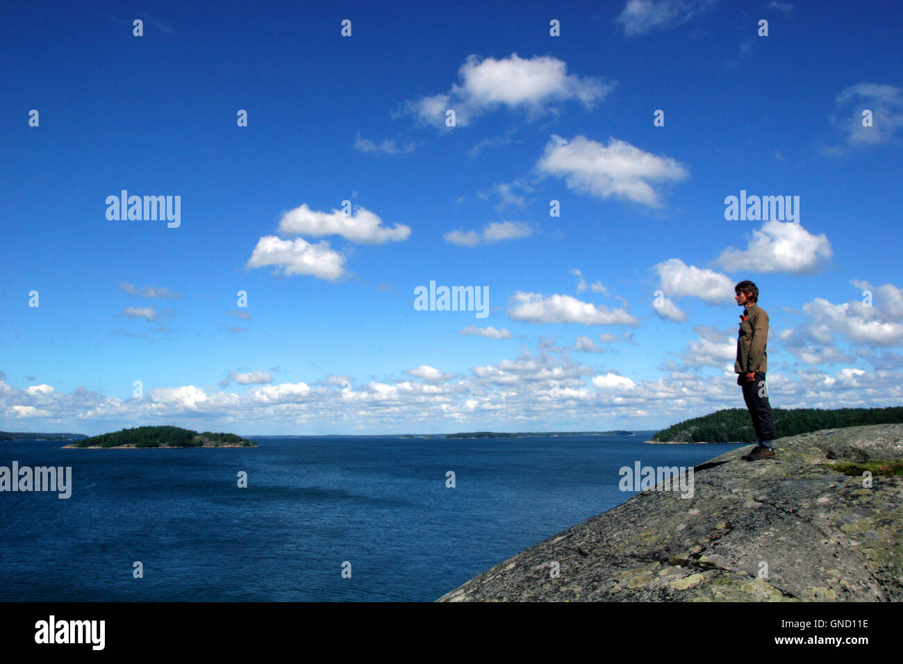 Man on an island watching the Baltic Sea, Finland Stock Photo - Alamy