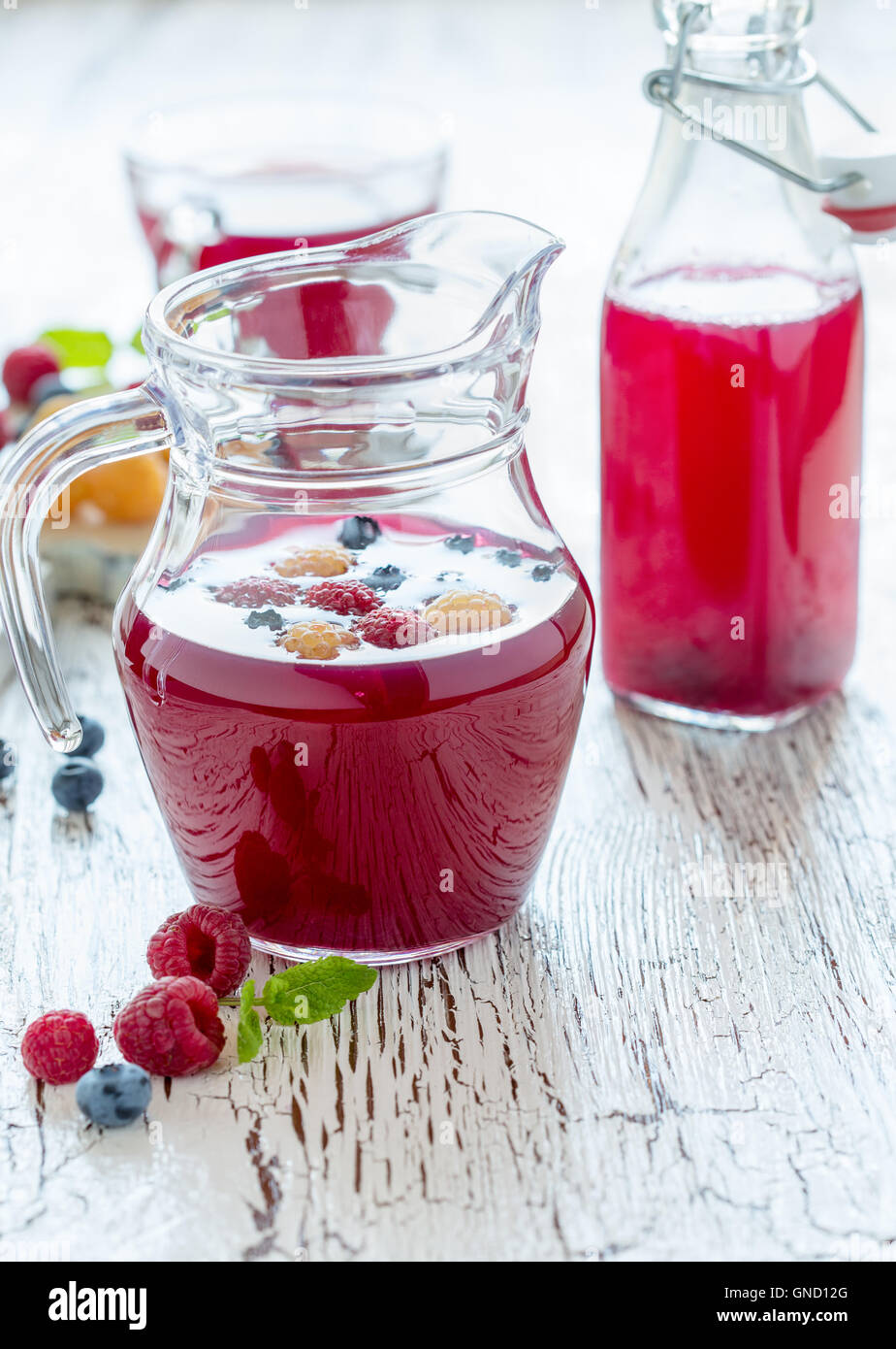 Homemade summer berry tea with rasbarry, blueberry and mint on rustic ...