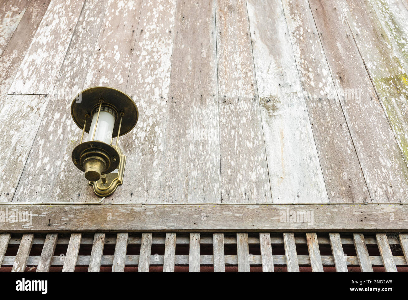 The old style lantern hang on old wooden wall Stock Photo - Alamy