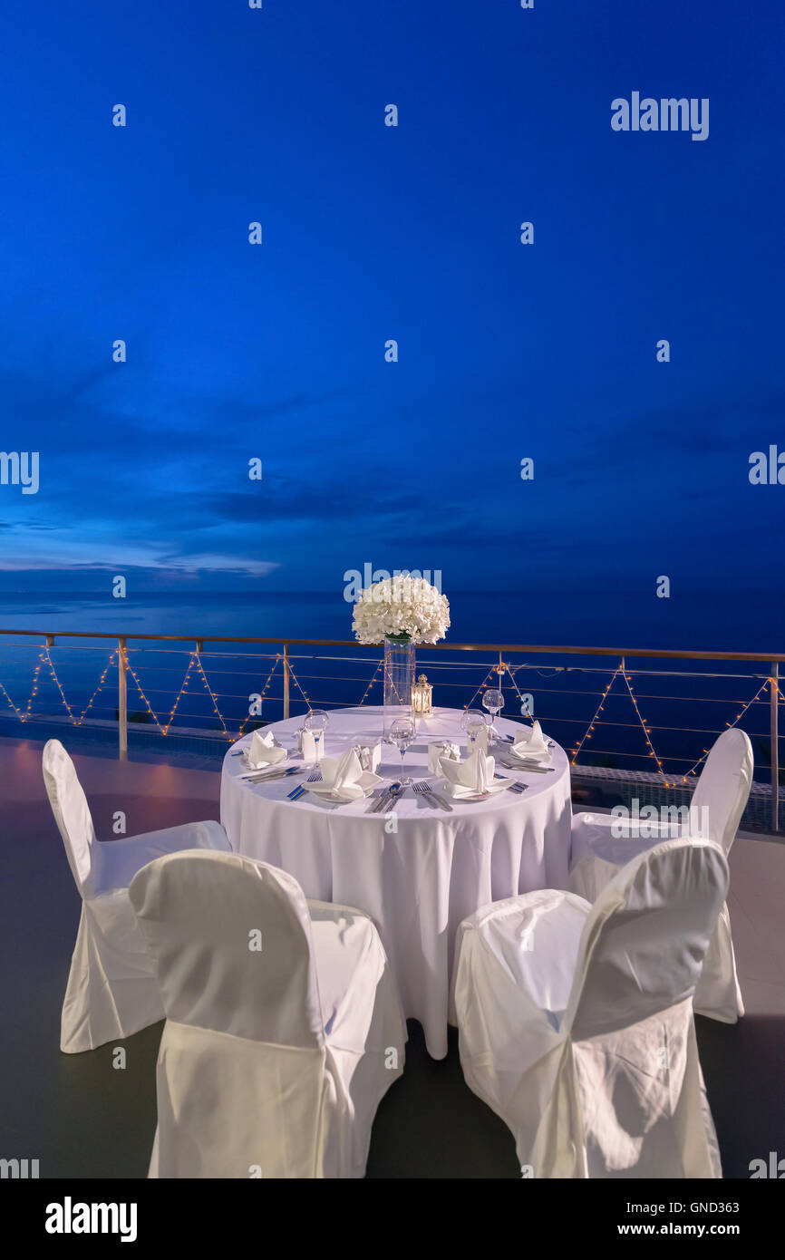 Romantic dinner setup, decoration with candle light. Selective focus ...