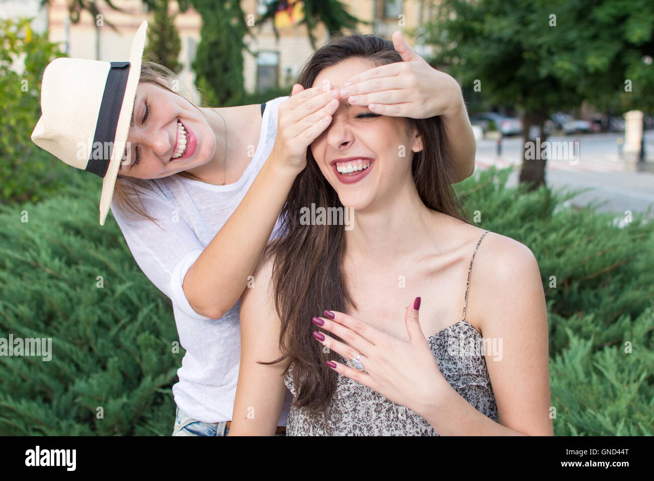 Who is there. Two girls having fun in the park Stock Photo - Alamy