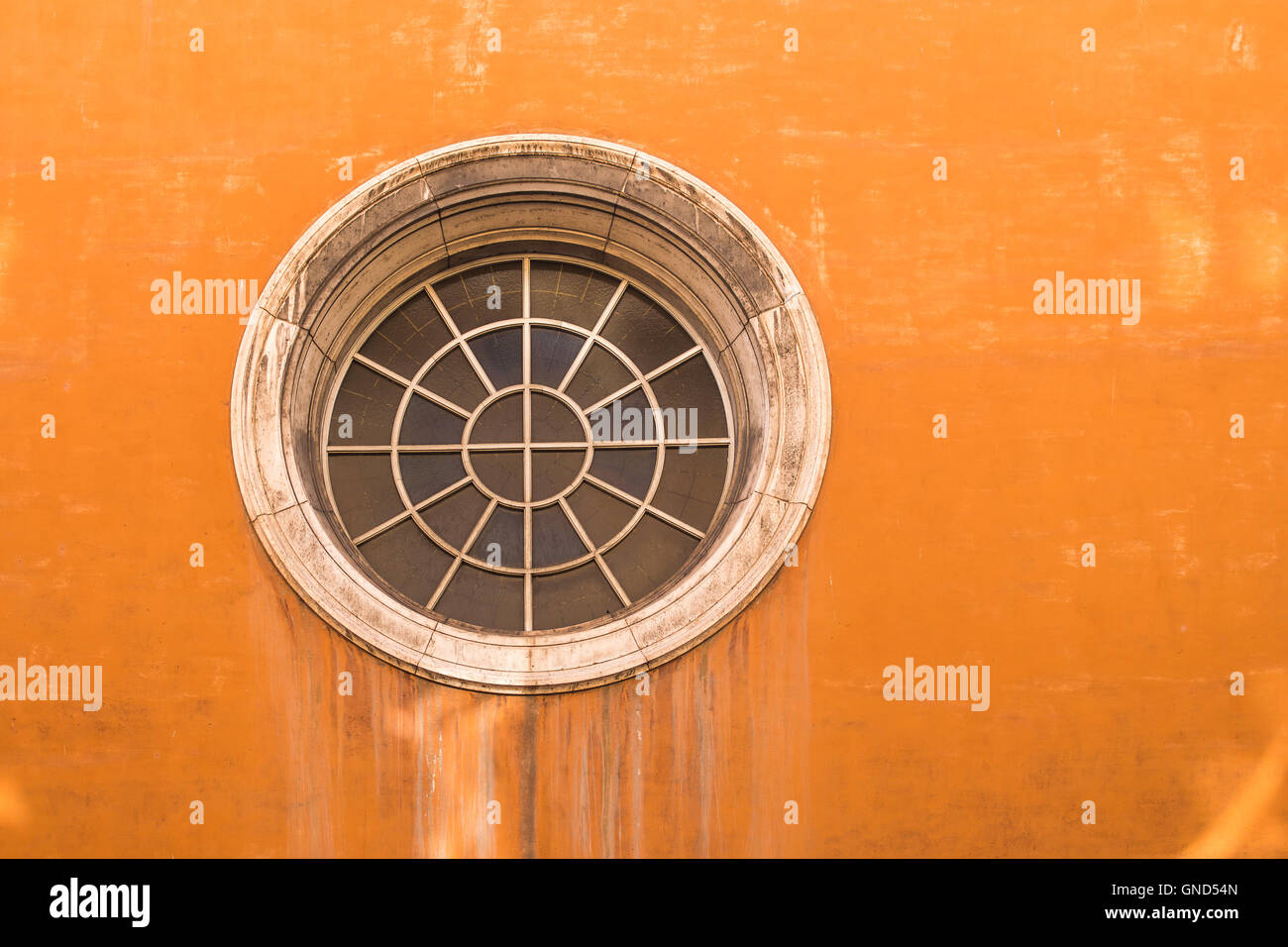 Typical orange color of the facade of a house in Rome. Unusual round ...
