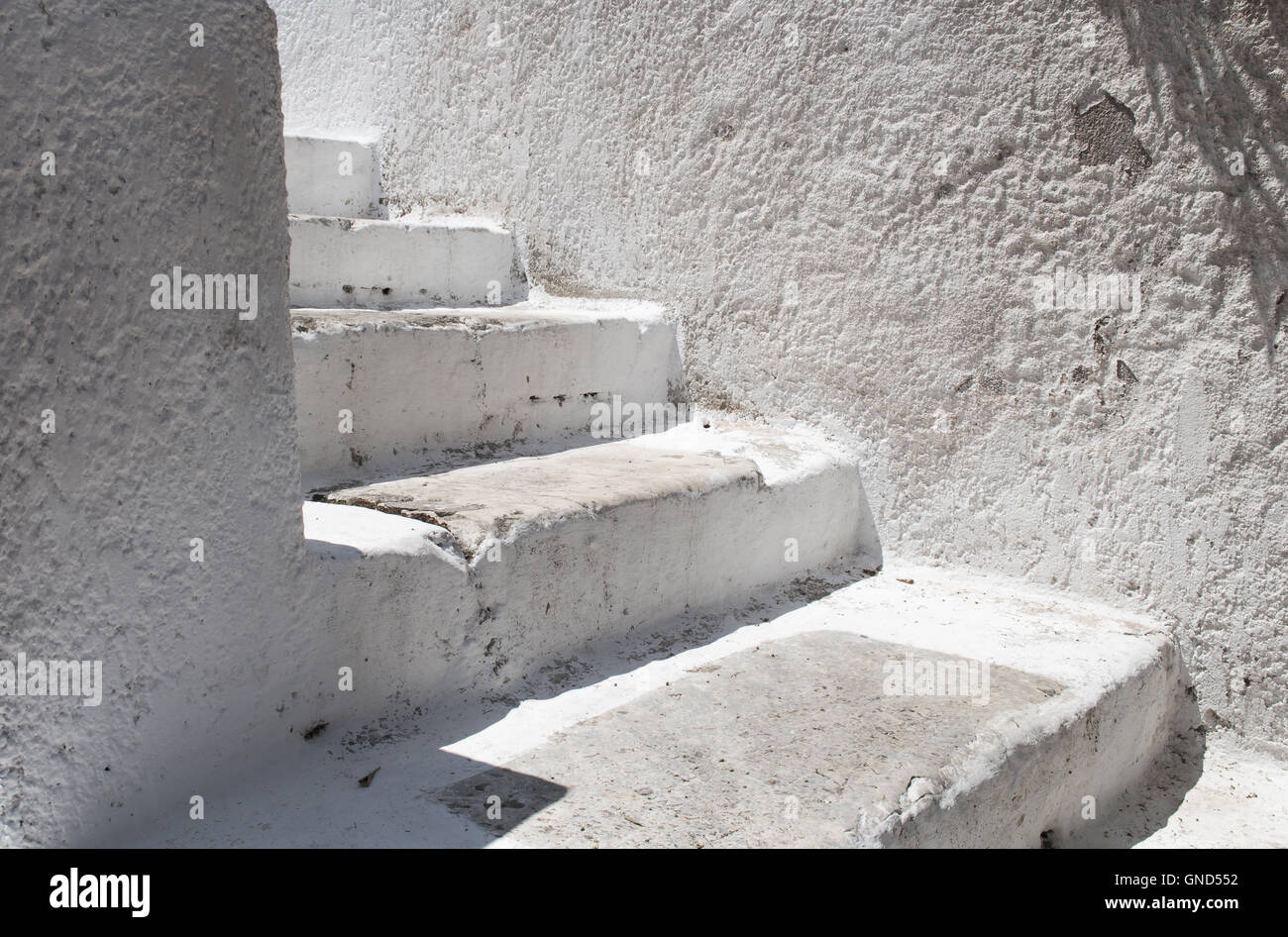 White stairs to the house between two walls with a white facade. Athens ...