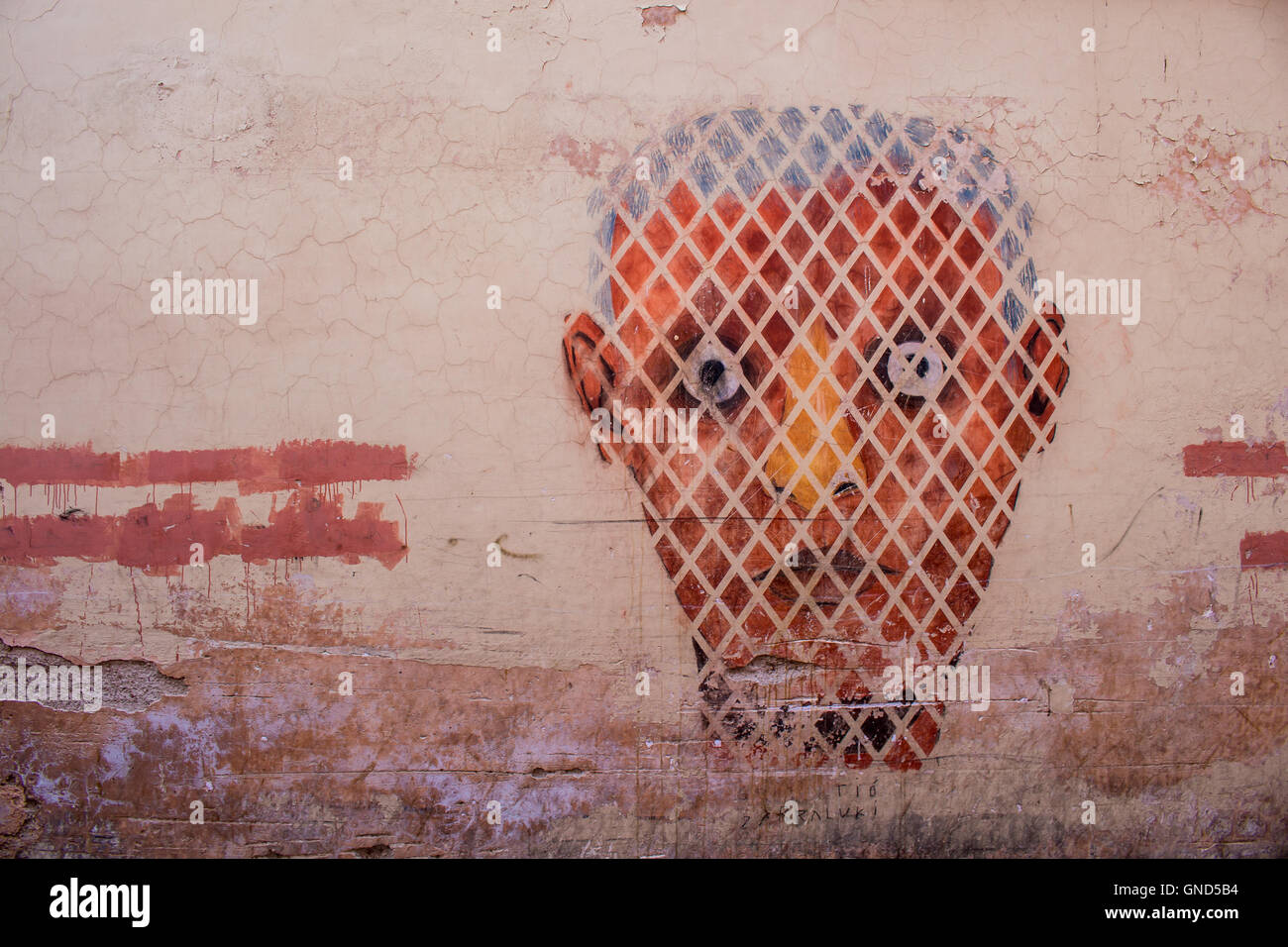 Wall in the medina of Marrakesh with graffiti of a textured man face ...