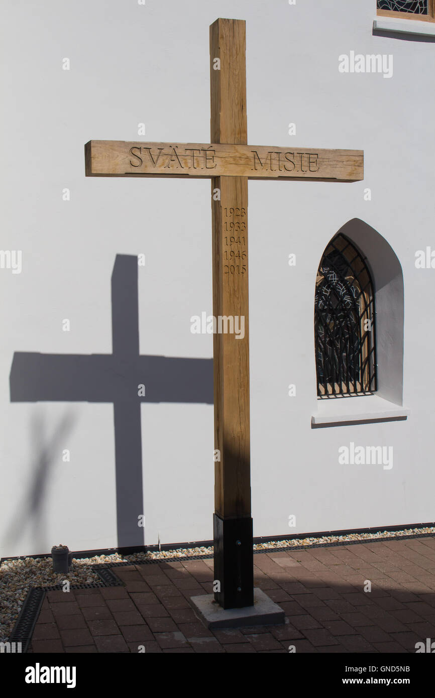 Wooden cross with a years of Saint Missions and its shadow on the wall ...