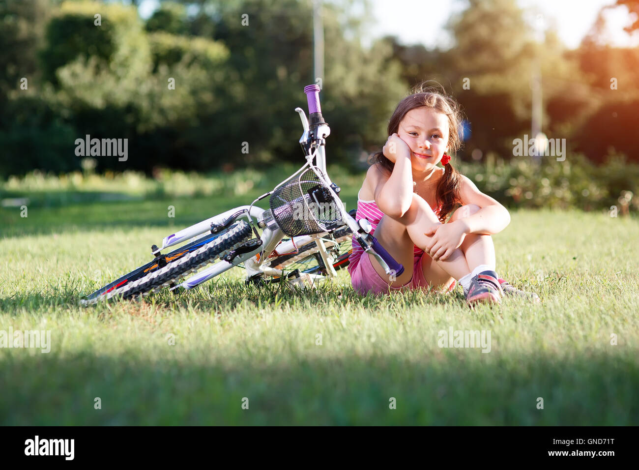 happy girl riding bicycle in summer sunset in the park Stock Photo - Alamy