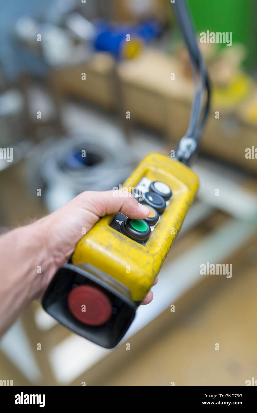 Industrial worker pushing on button of machinery controler Stock Photo ...