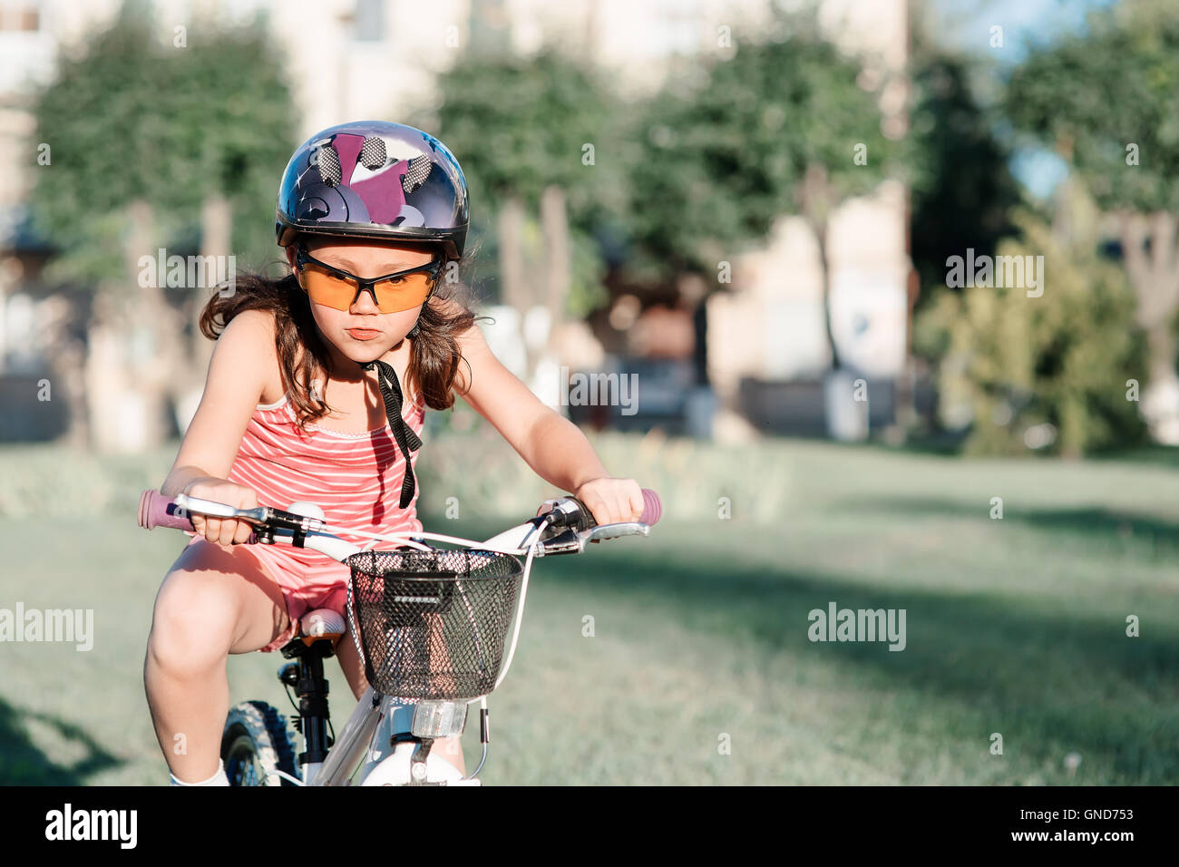 happy girl riding bicycle in summer sunset in the park Stock Photo - Alamy