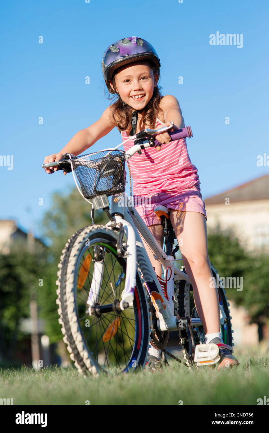 happy girl riding bicycle in summer sunset in the park Stock Photo - Alamy