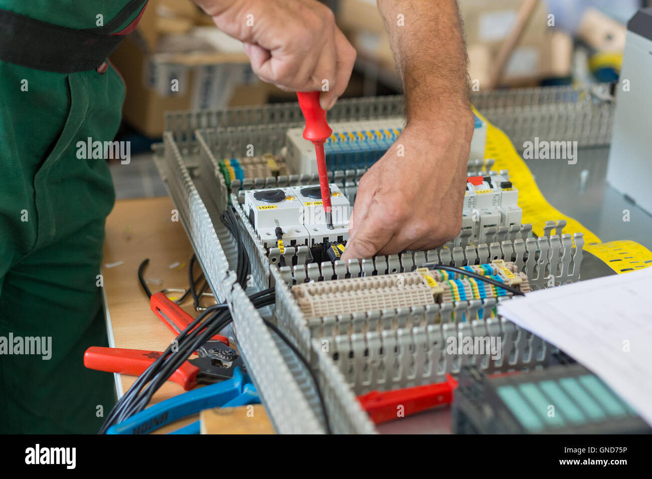 Electrician assembling industrial electric cabinet Stock Photo - Alamy